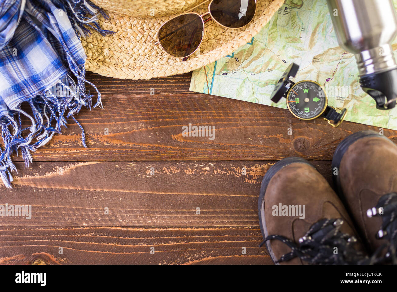 Hiking shoes with topo map and compass on a wood background Stock Photo ...