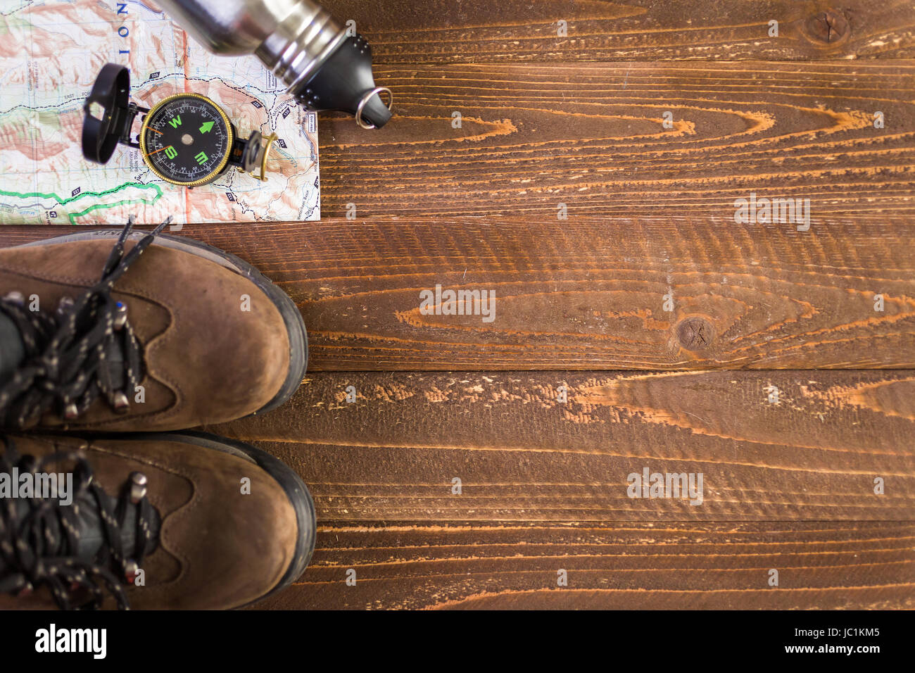 Hiking shoes with topo map and compass on a wood background Stock Photo ...