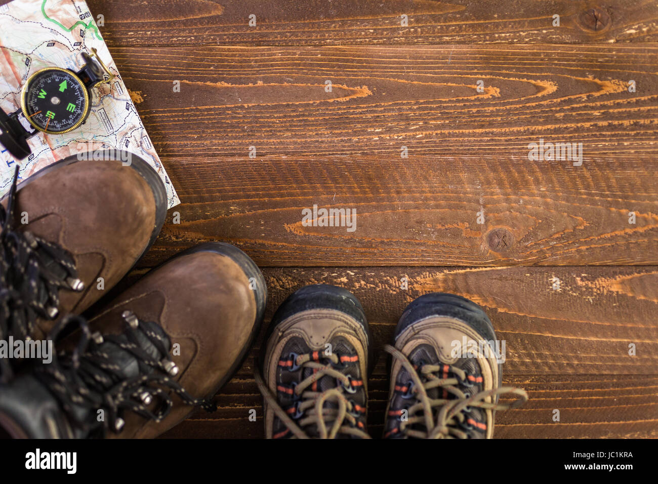 Hiking shoes with topo map and compass on a wood background Stock Photo ...