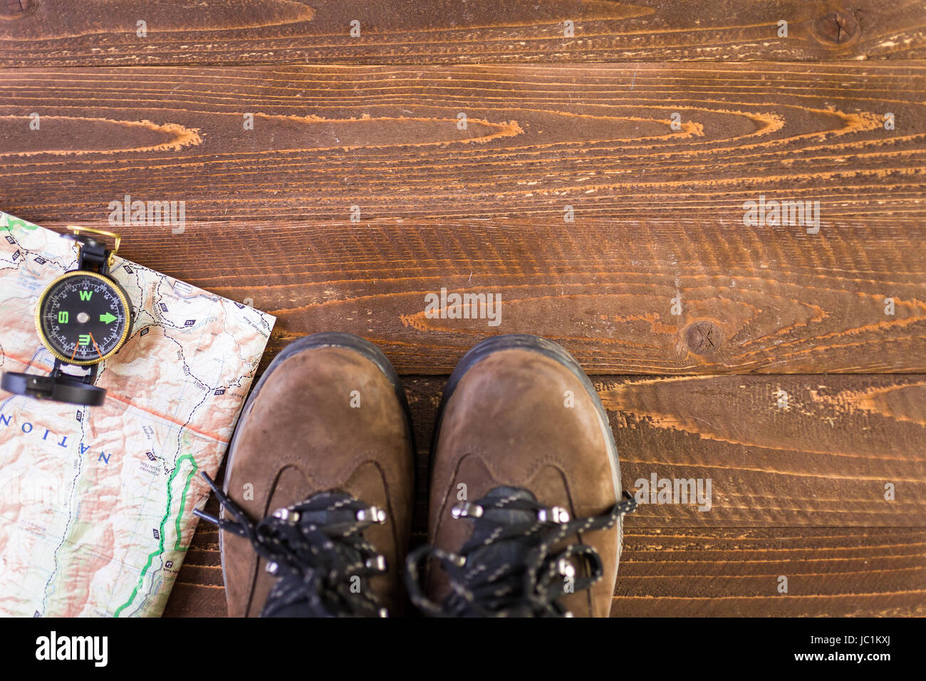 Hiking shoes with topo map and compass on a wood background Stock Photo ...