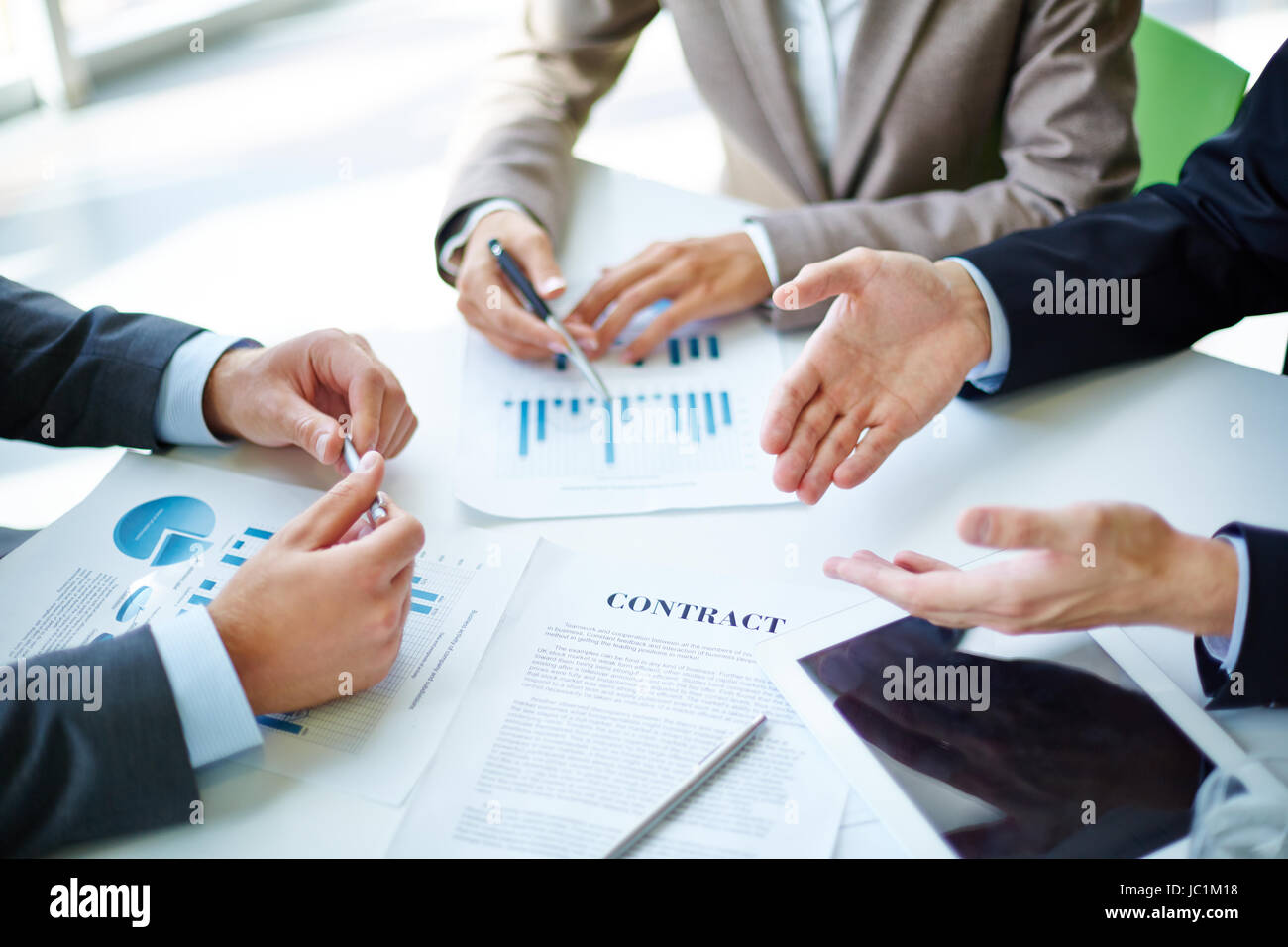 Image of business partners hands over business objects on workplace at ...