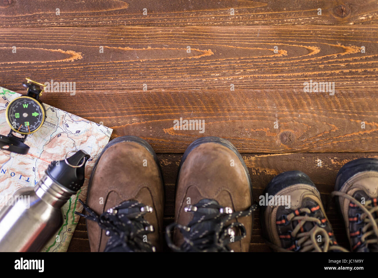 Hiking shoes with topo map and compass on a wood background Stock Photo ...