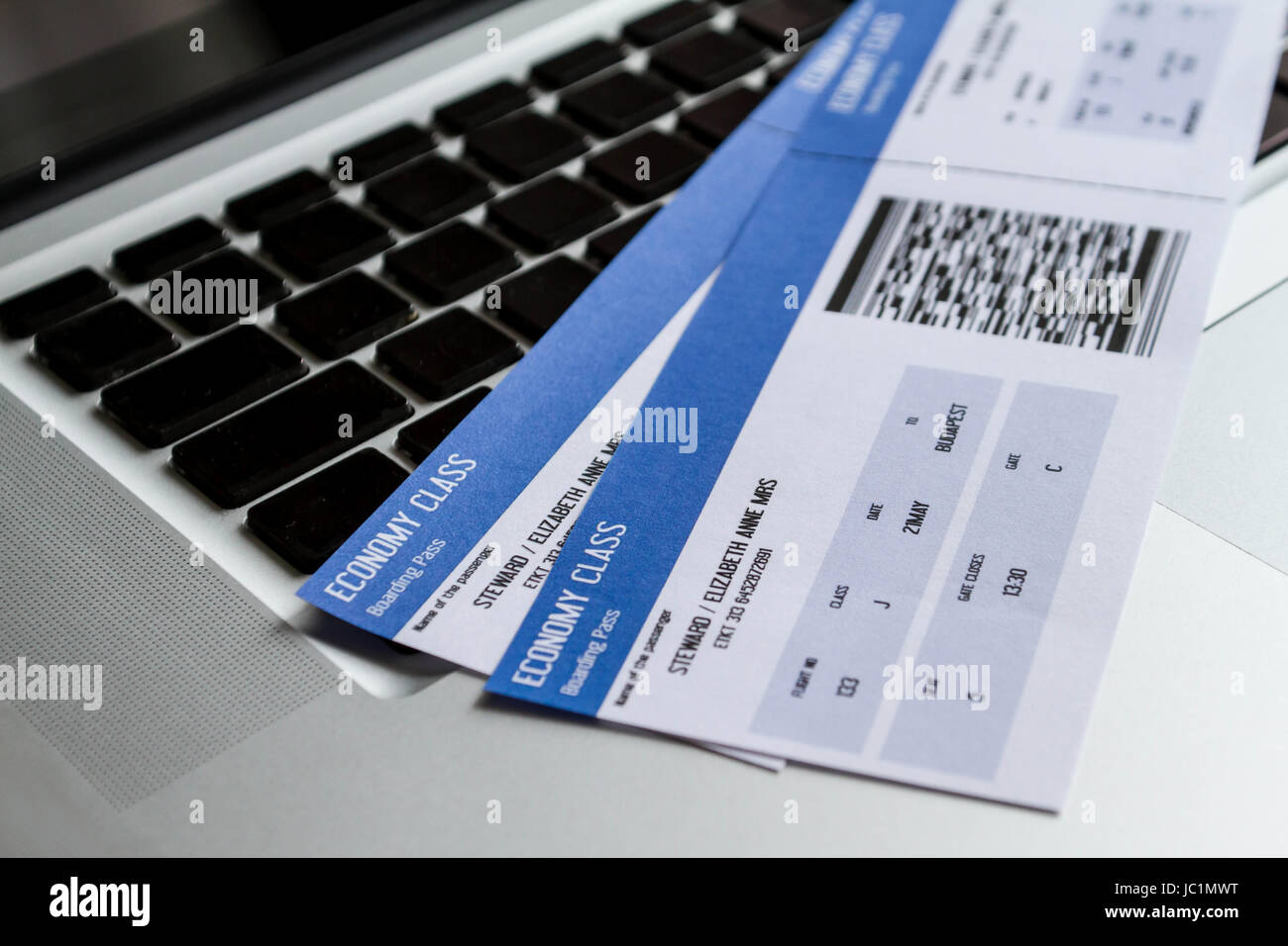 Airline tickets over the keyboard of a laptop Stock Photo - Alamy