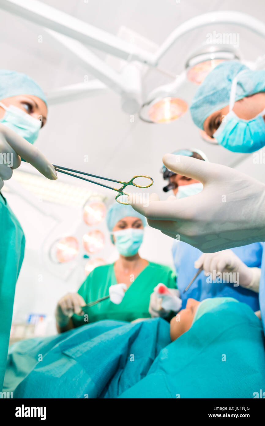 Hospital - surgery team in the operating room or Op of clinic operating ...