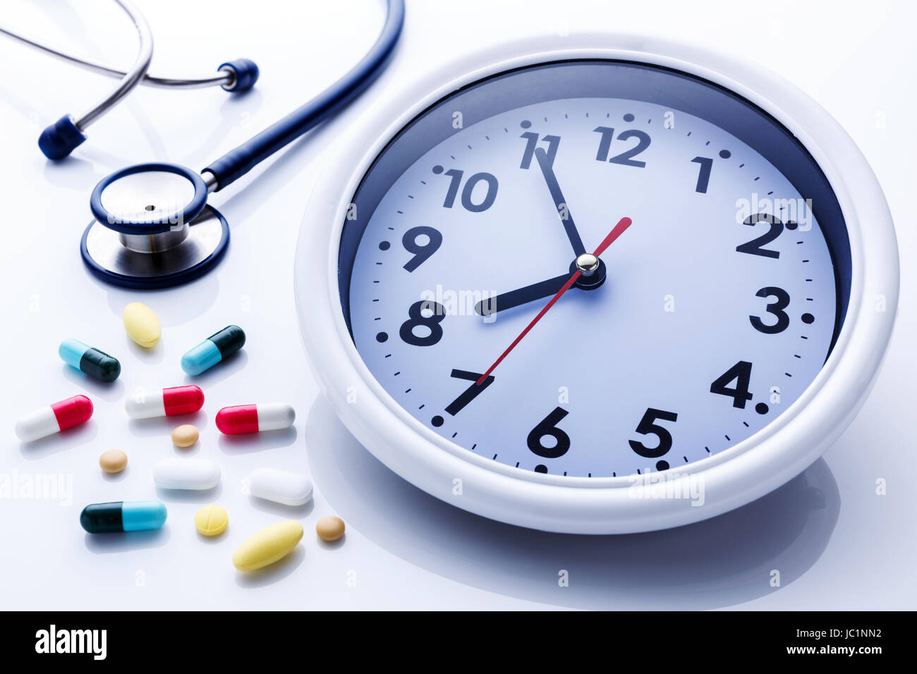 Clock with medicine and medical stethoscope Stock Photo - Alamy