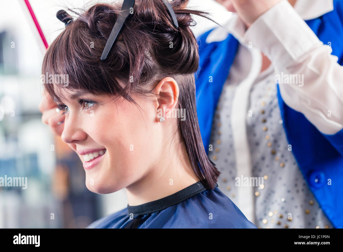 Female coiffeur divide women hair in sections with clips in shop Stock ...