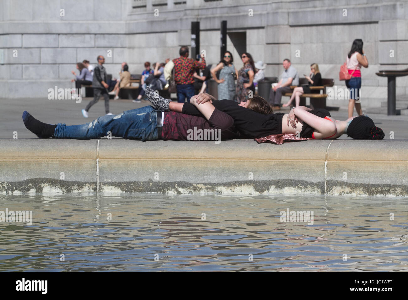 London, UK. 13th June, 2017. People sunbathing by Trafalgar Square ...