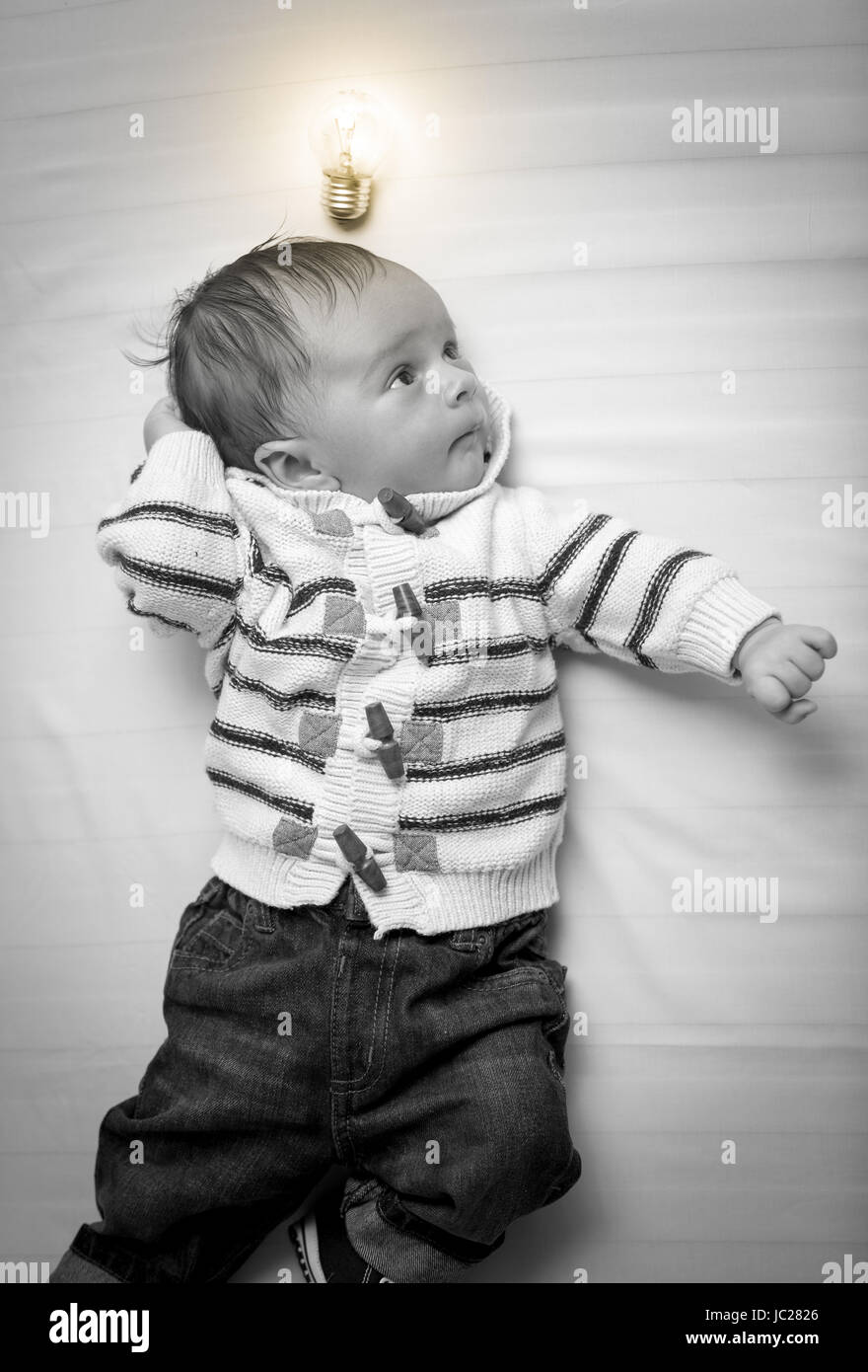 Black and white portrait of smart baby boy with glowing light bulb ...