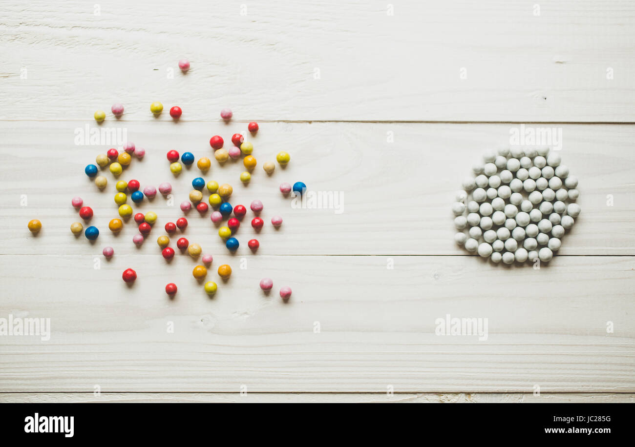 Chaotic colorful balls and organized white balls. Concept of order and ...