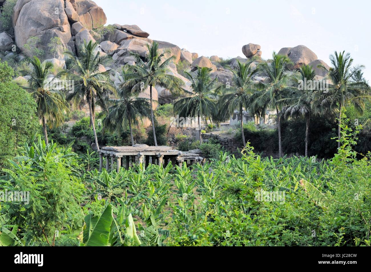 Ancient ruins of Vijayanagara Empire at sunset blue sky in Hampi ...