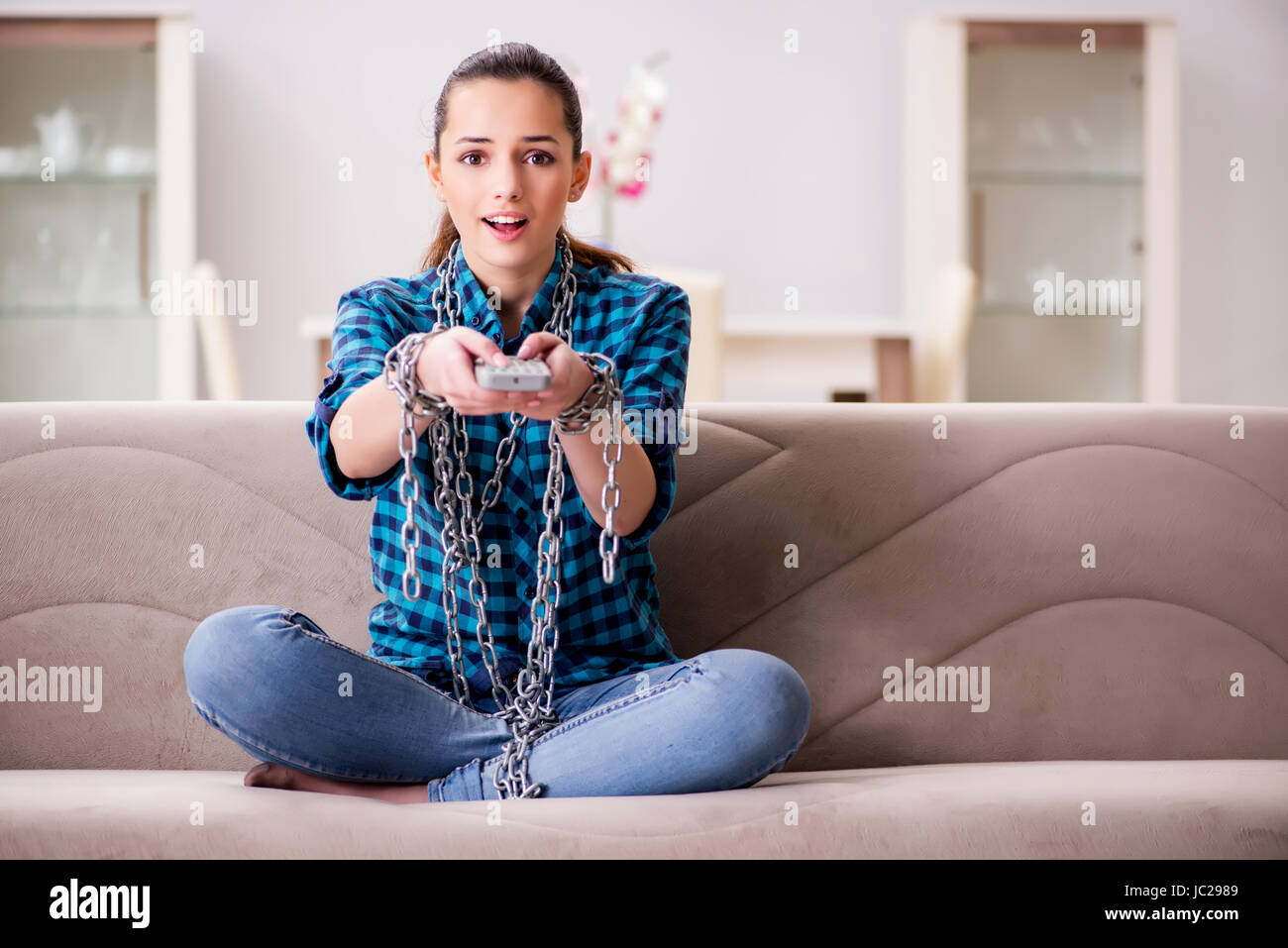 Young girl addicted to tv wasting her time Stock Photo - Alamy