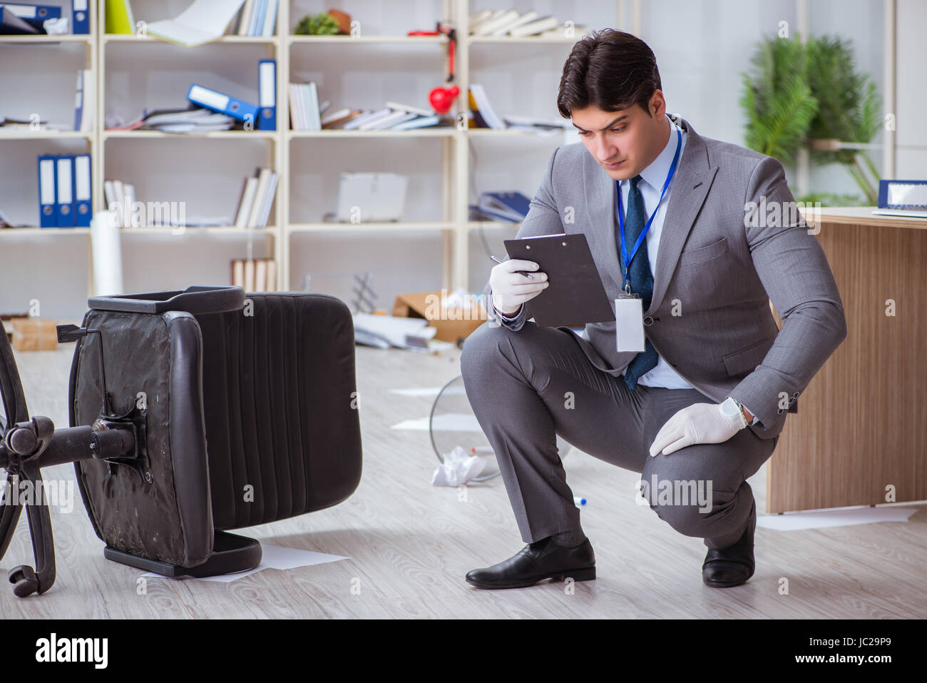 Young man during crime investigation in office Stock Photo - Alamy