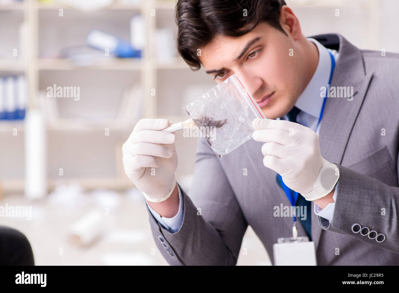 Young man during crime investigation in office Stock Photo - Alamy