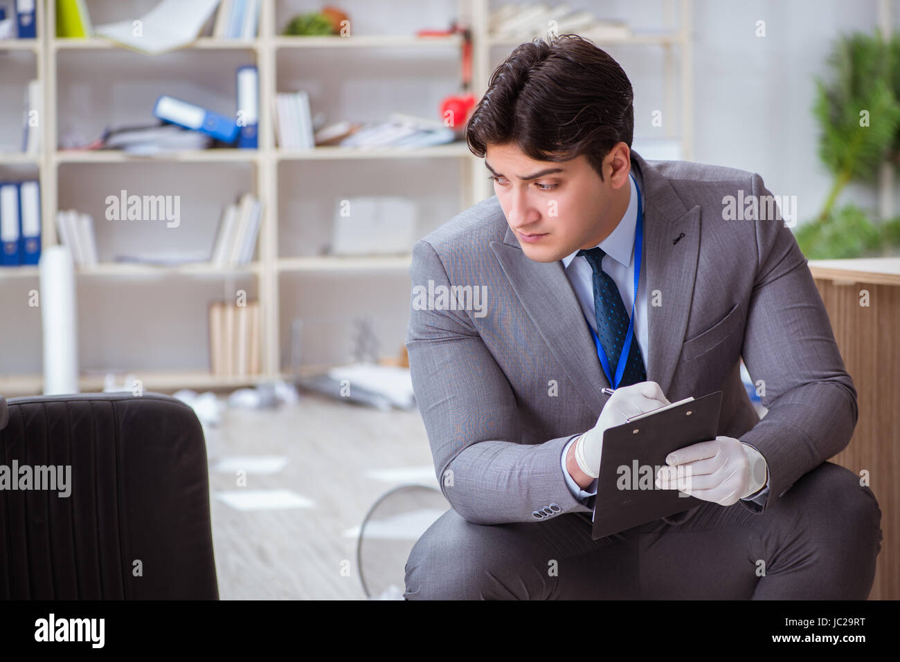 Young man during crime investigation in office Stock Photo - Alamy