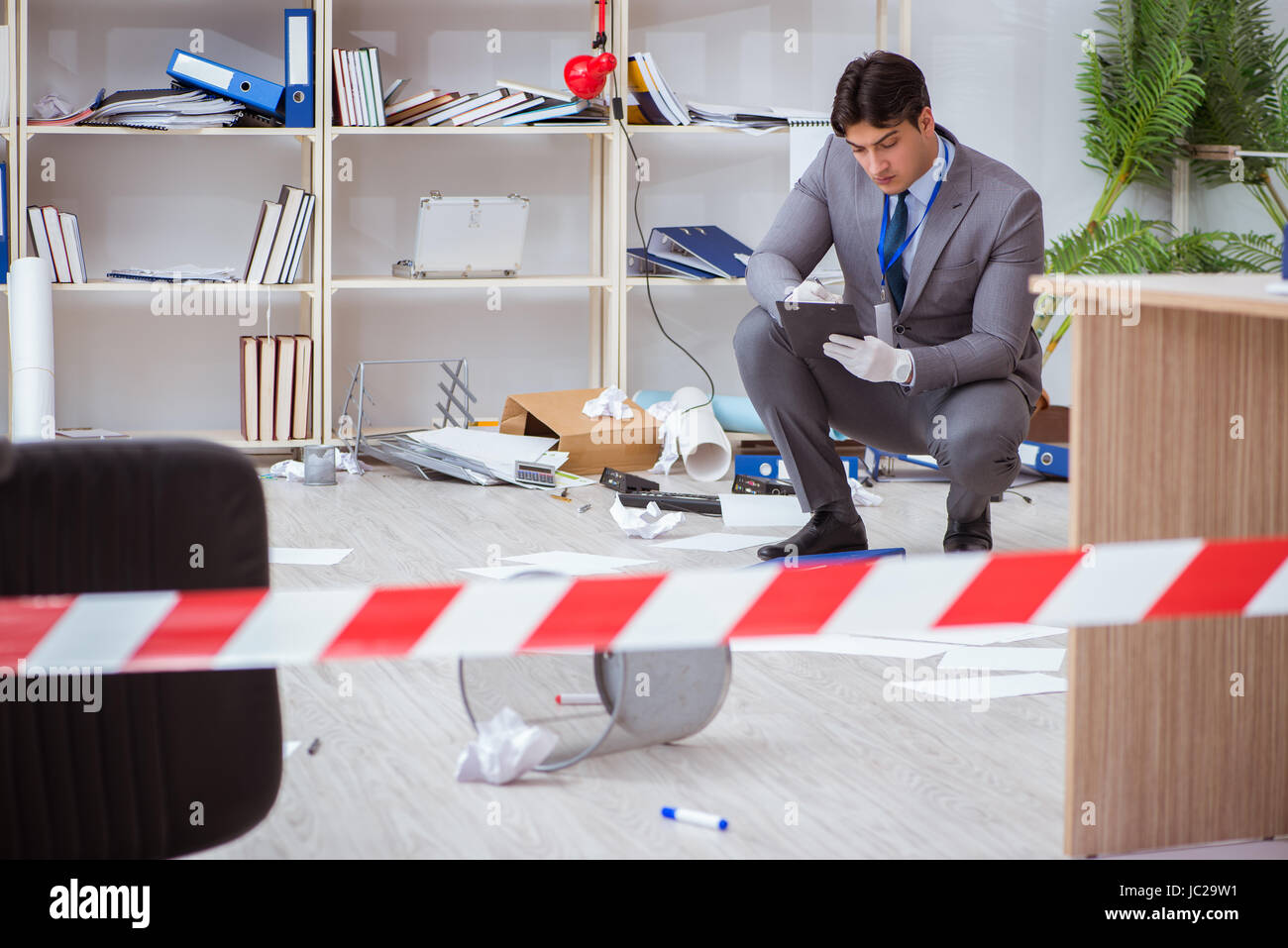 Young man during crime investigation in office Stock Photo - Alamy