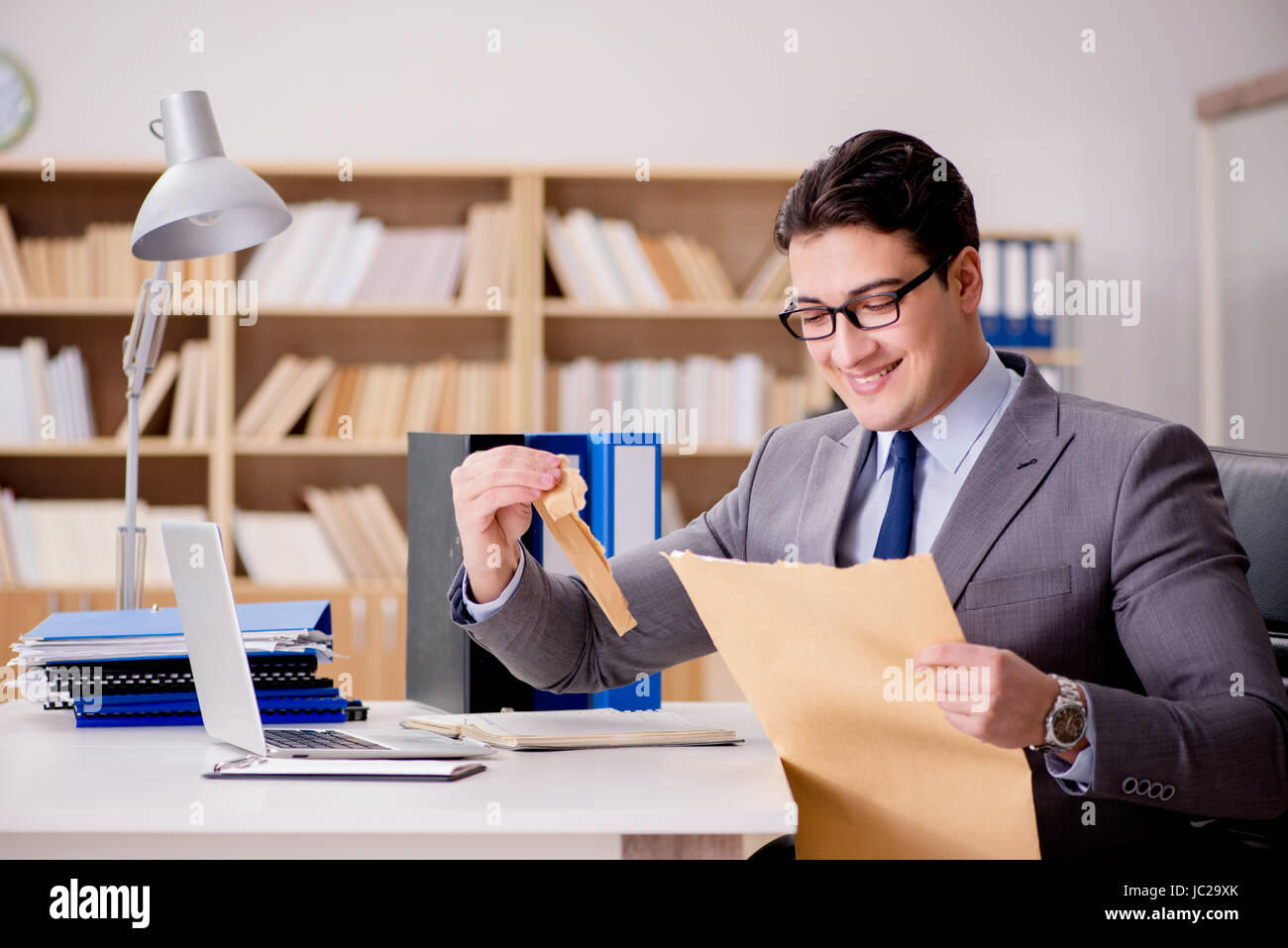 Businessman receiving letter envelope in office Stock Photo - Alamy