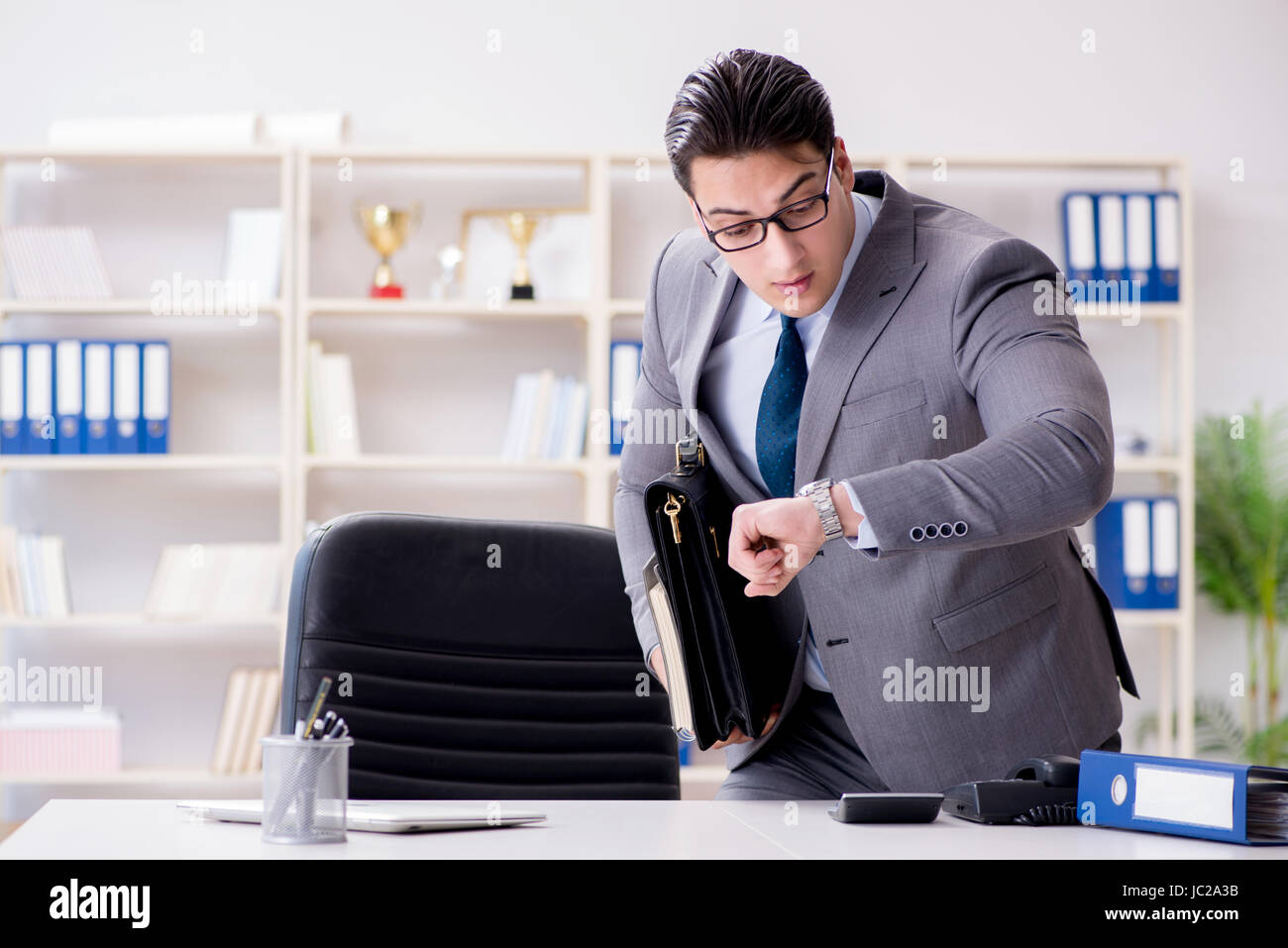 Businessman rushing in the office Stock Photo - Alamy
