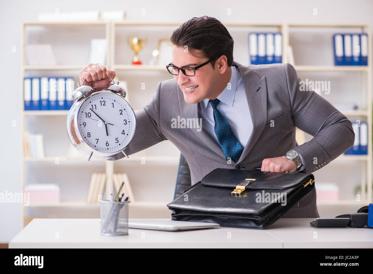 Businessman rushing in the office Stock Photo - Alamy