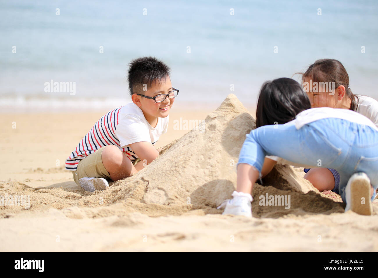 Children and Sand Tunnel Stock Photo - Alamy
