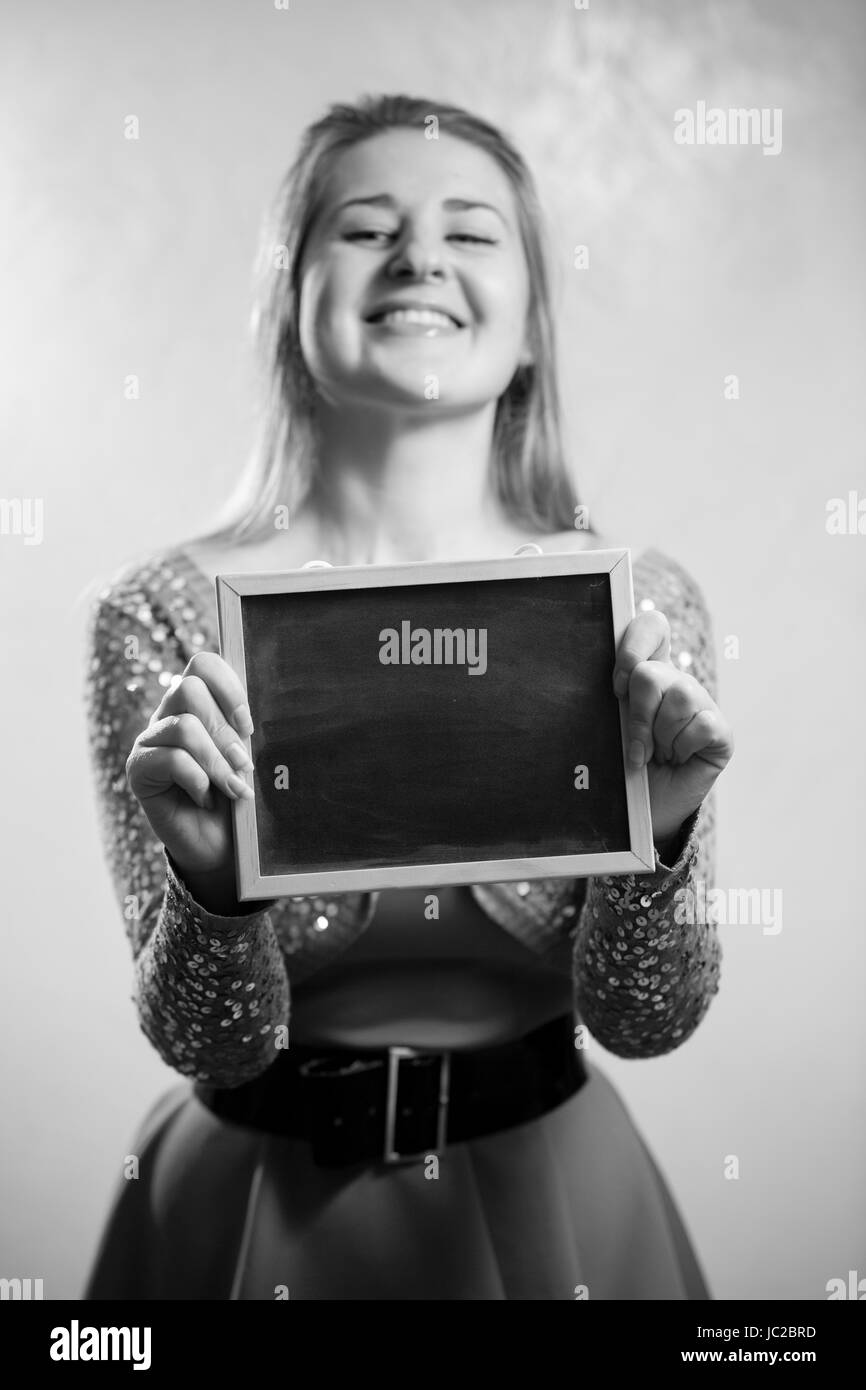 Black and white portrait of happy woman holding empty blackboard Stock ...
