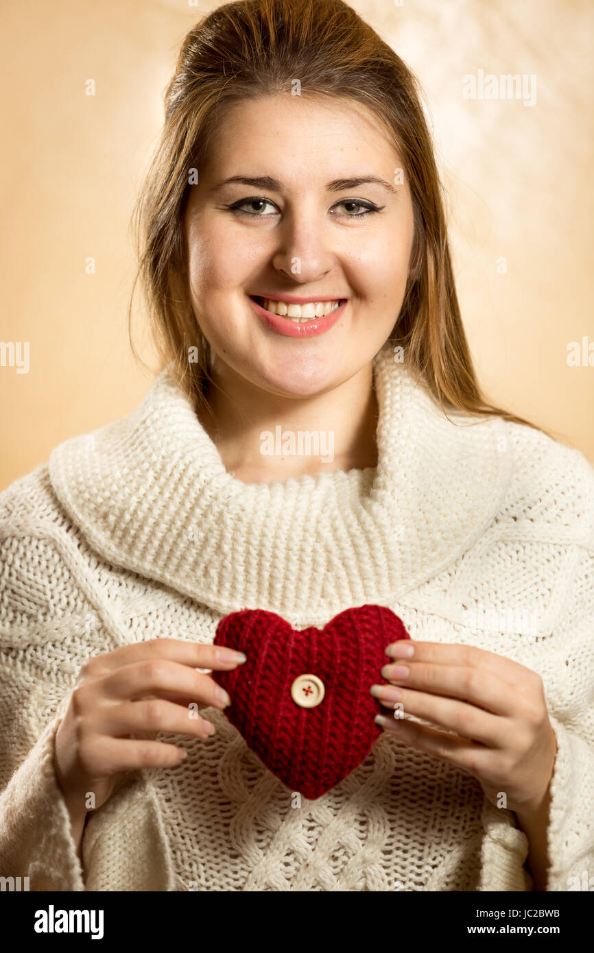 Portrait of beautiful cute woman posing with knitted heart Stock Photo ...