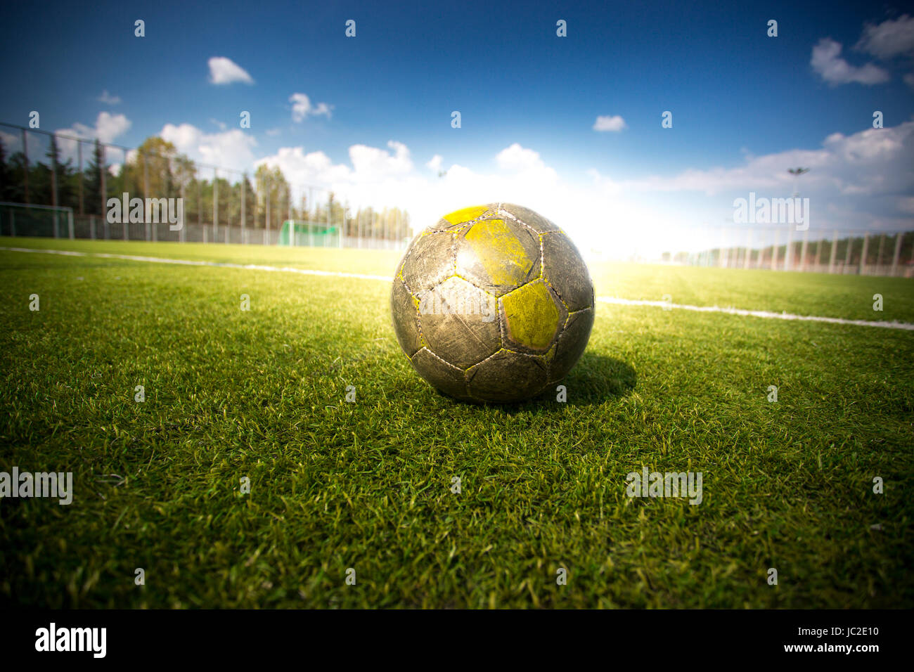 Closeup shot of soccer football on grass field at sun beams Stock Photo ...