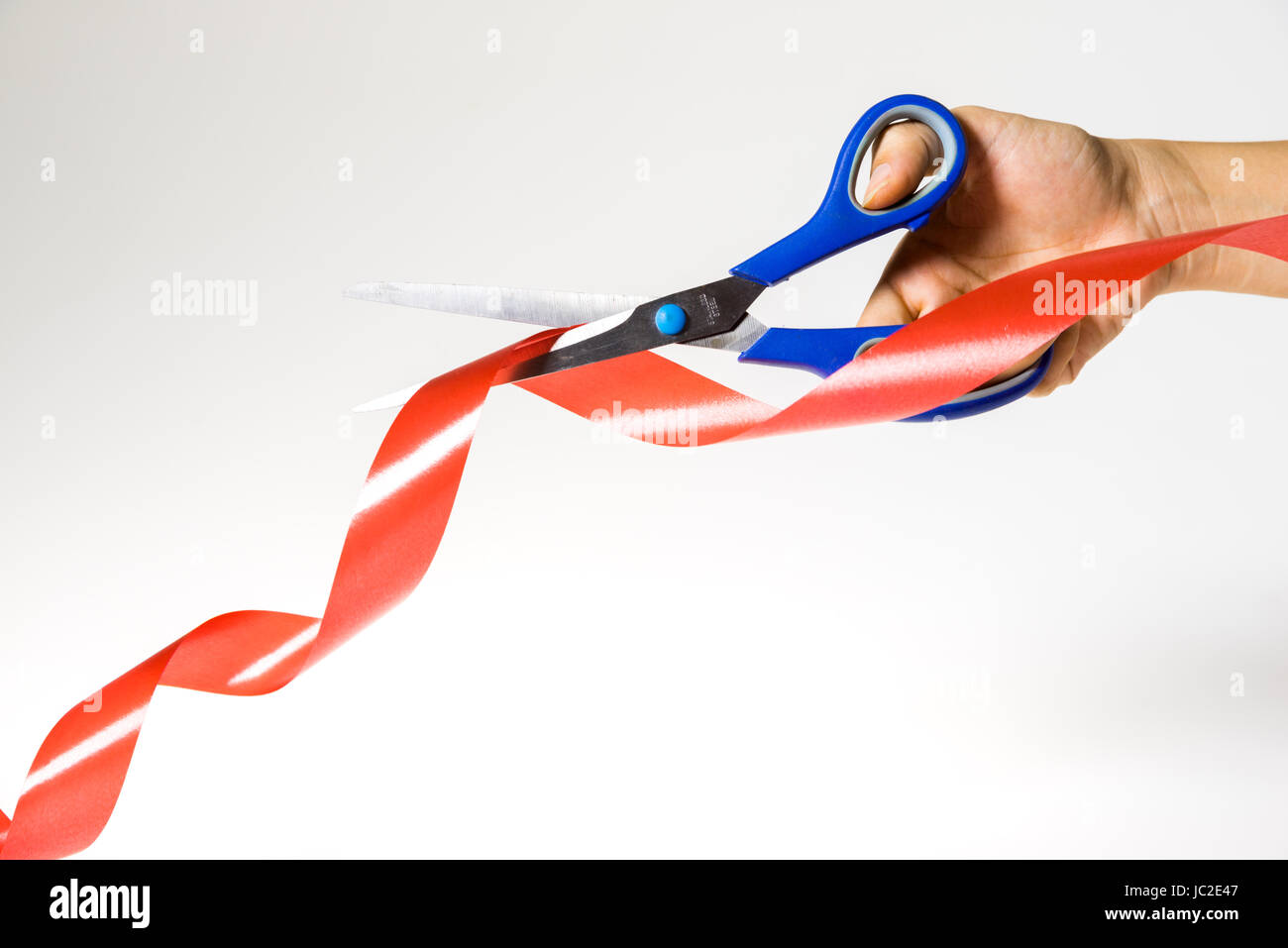 Scissors Cutting Red Ribbon on white background isolated Stock Photo ...