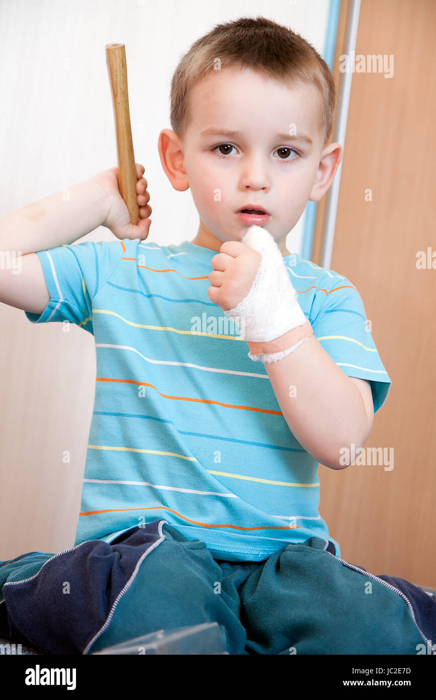 wounded in the left hand with bandage boy at shot in home Stock Photo ...