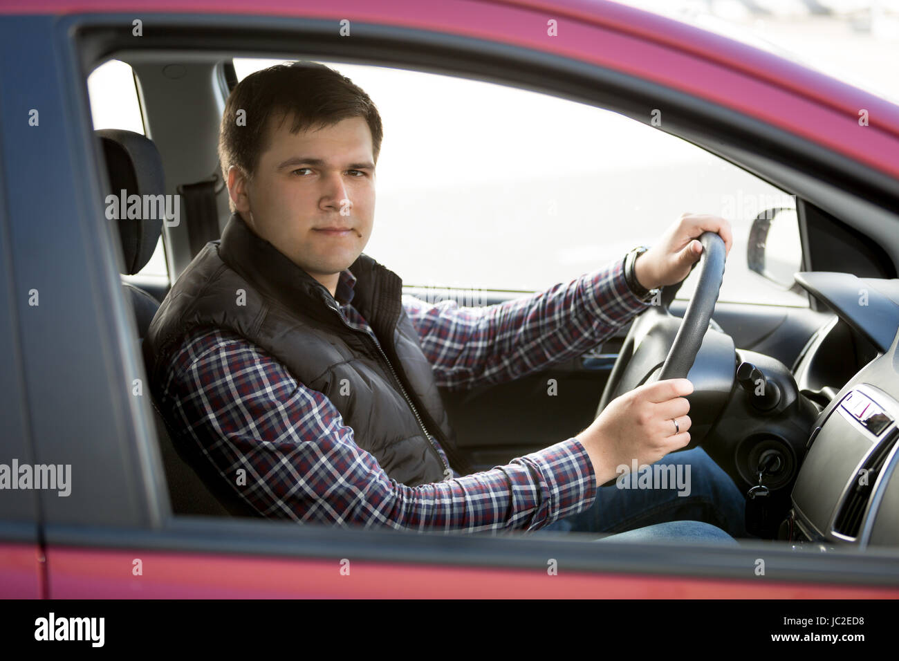Portrait of happy young man driving small car Stock Photo - Alamy