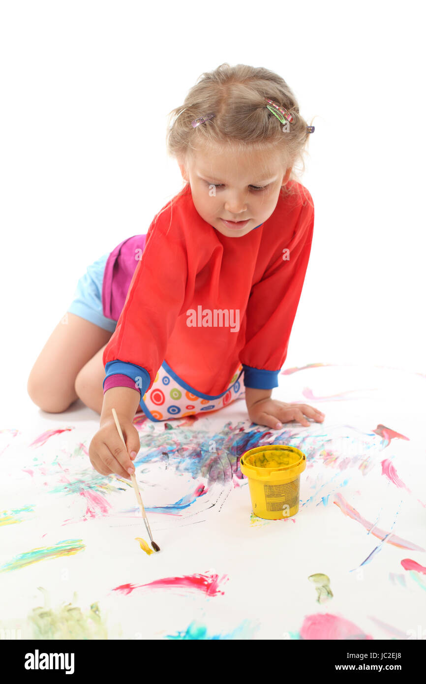 Little girl painting with paintbrush Stock Photo - Alamy