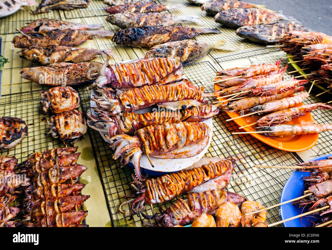 Grilled cuttlefish and other seafood at Asian night market Stock Photo ...