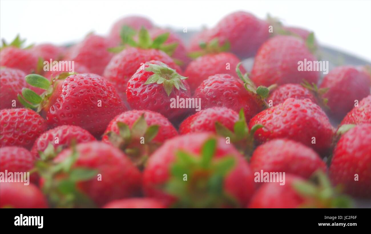 Fresh, ripe, juicy strawberries rotate with steam after freezer. or ...