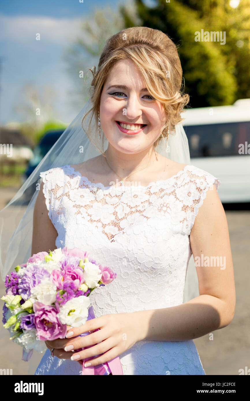 Closeup portrait of happy smiling bride posing in park with wedding ...