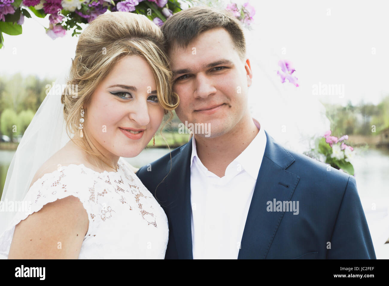 Toned closeup portrait of elegant bride and groom at wedding ceremony ...