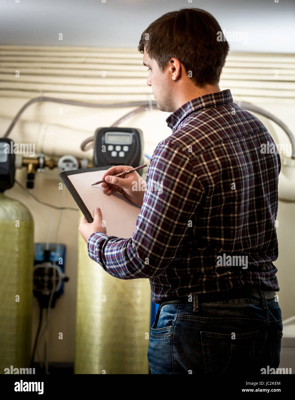 Closeup portrait of male engineer checking condition of factory ...