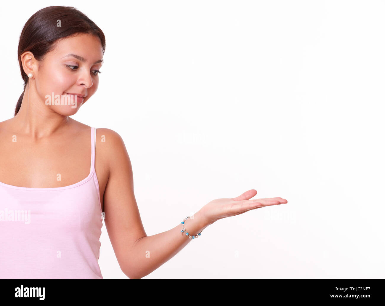 Portrait of 20-24 years cute lady holding her left hand up while ...