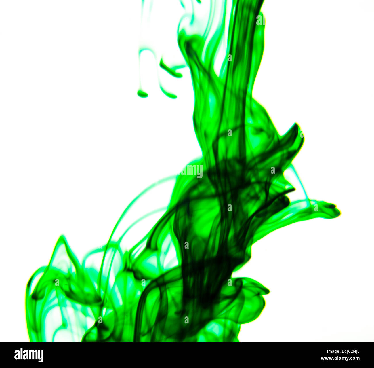 Vegetable ink poured into water with white background Stock Photo - Alamy