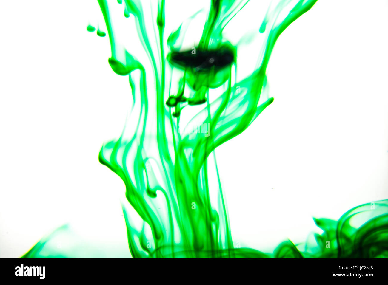 Vegetable ink poured into water with white background Stock Photo - Alamy