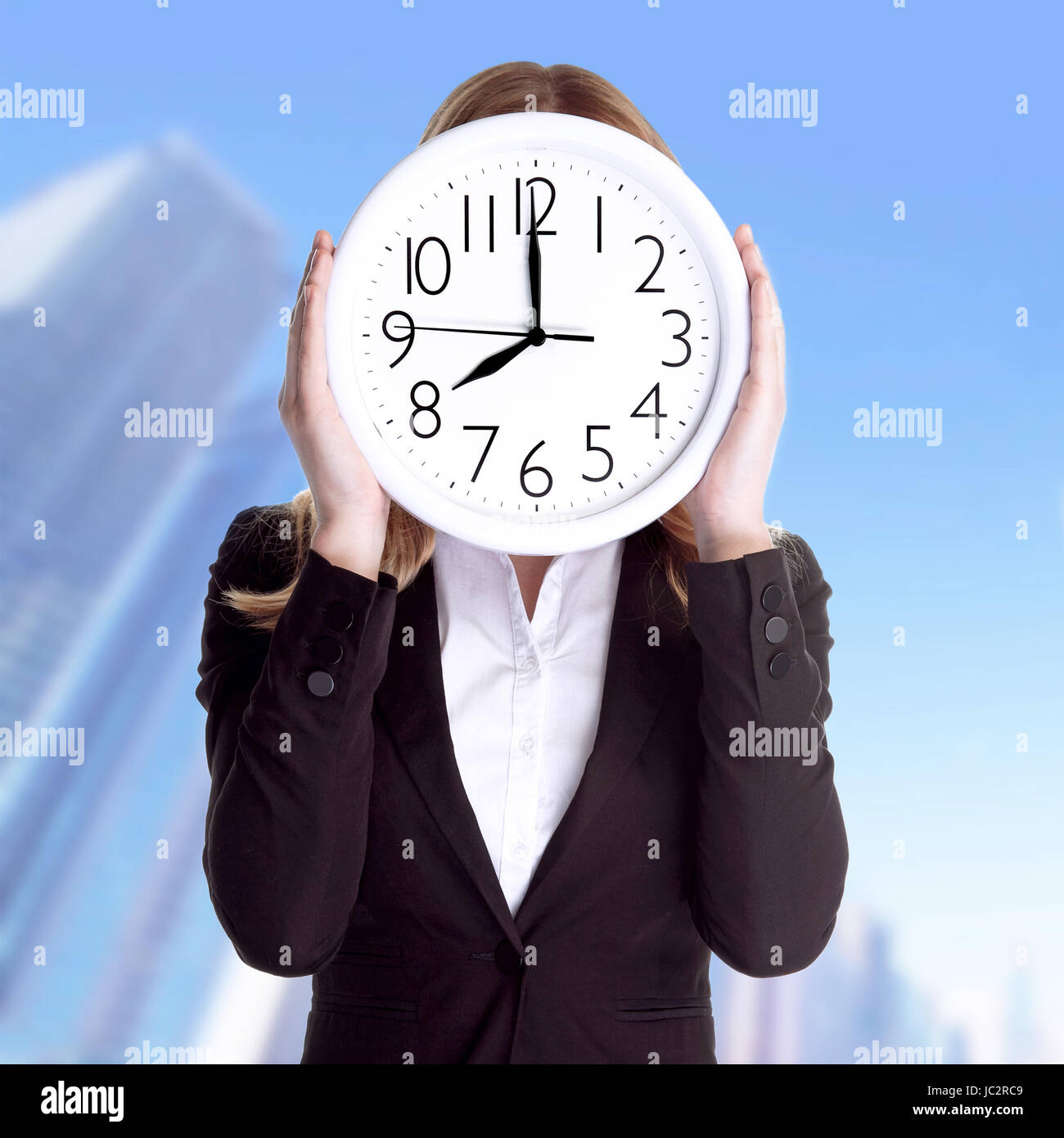 Woman holding clock showing oclock hi-res stock photography and images ...