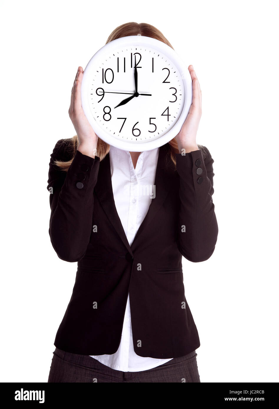 Business woman wearing formal suit and holding big clock on face ...