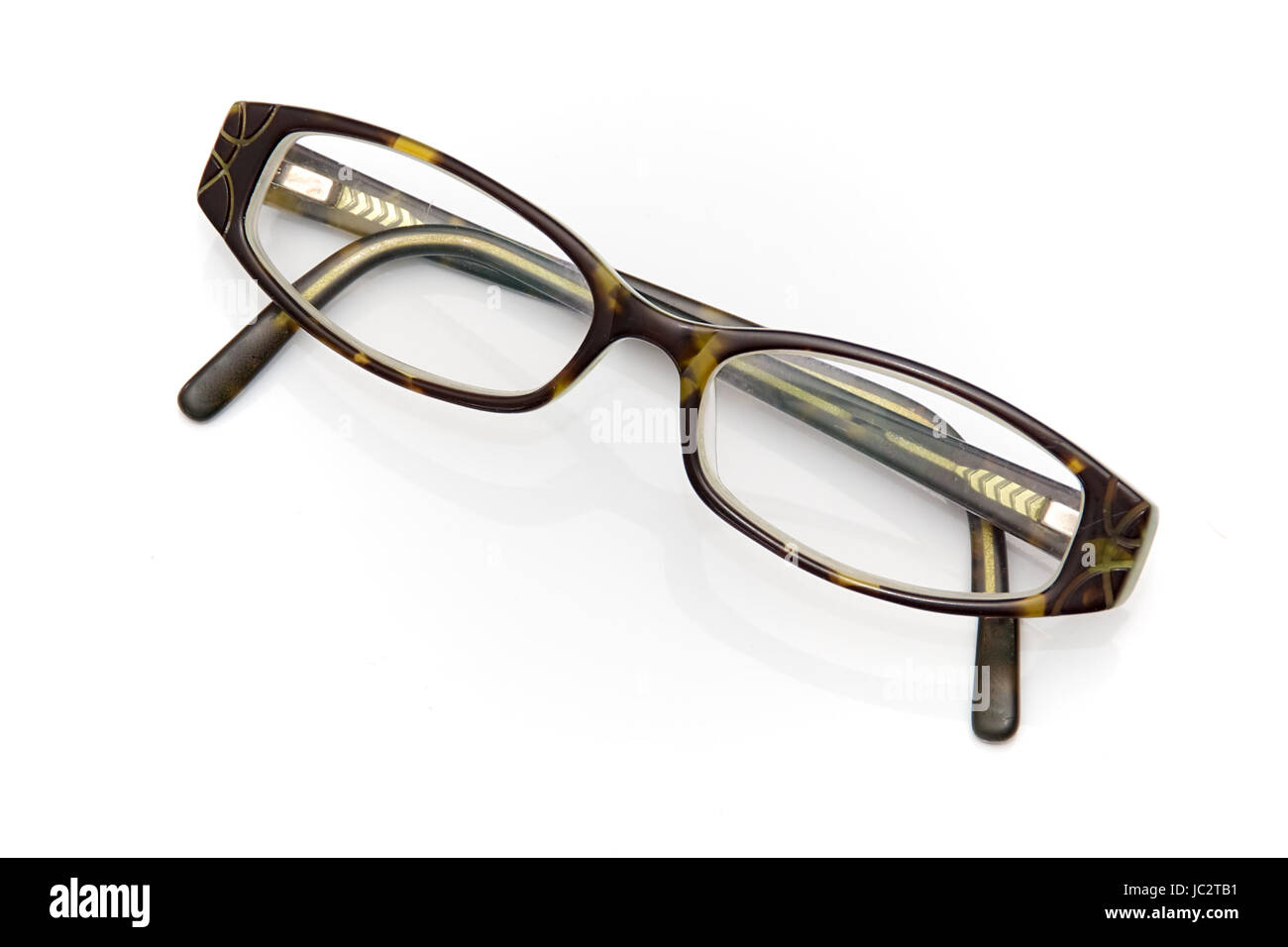 A pair of woman's vintage tortoise shell eyeglasses shot over white ...