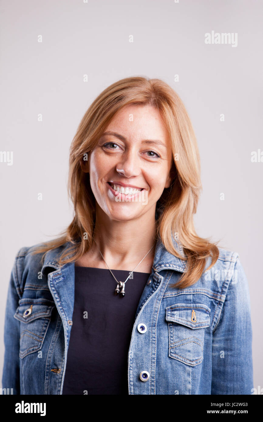 this is a real, natural, ordinary woman smiling at camera; not a model ...