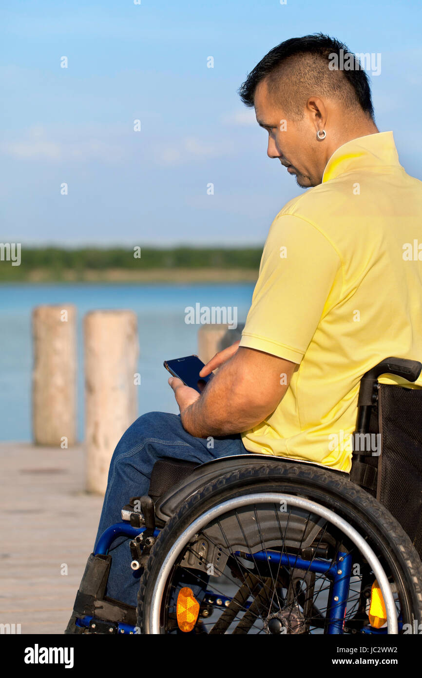 wheelchair driver with smartphone Stock Photo - Alamy