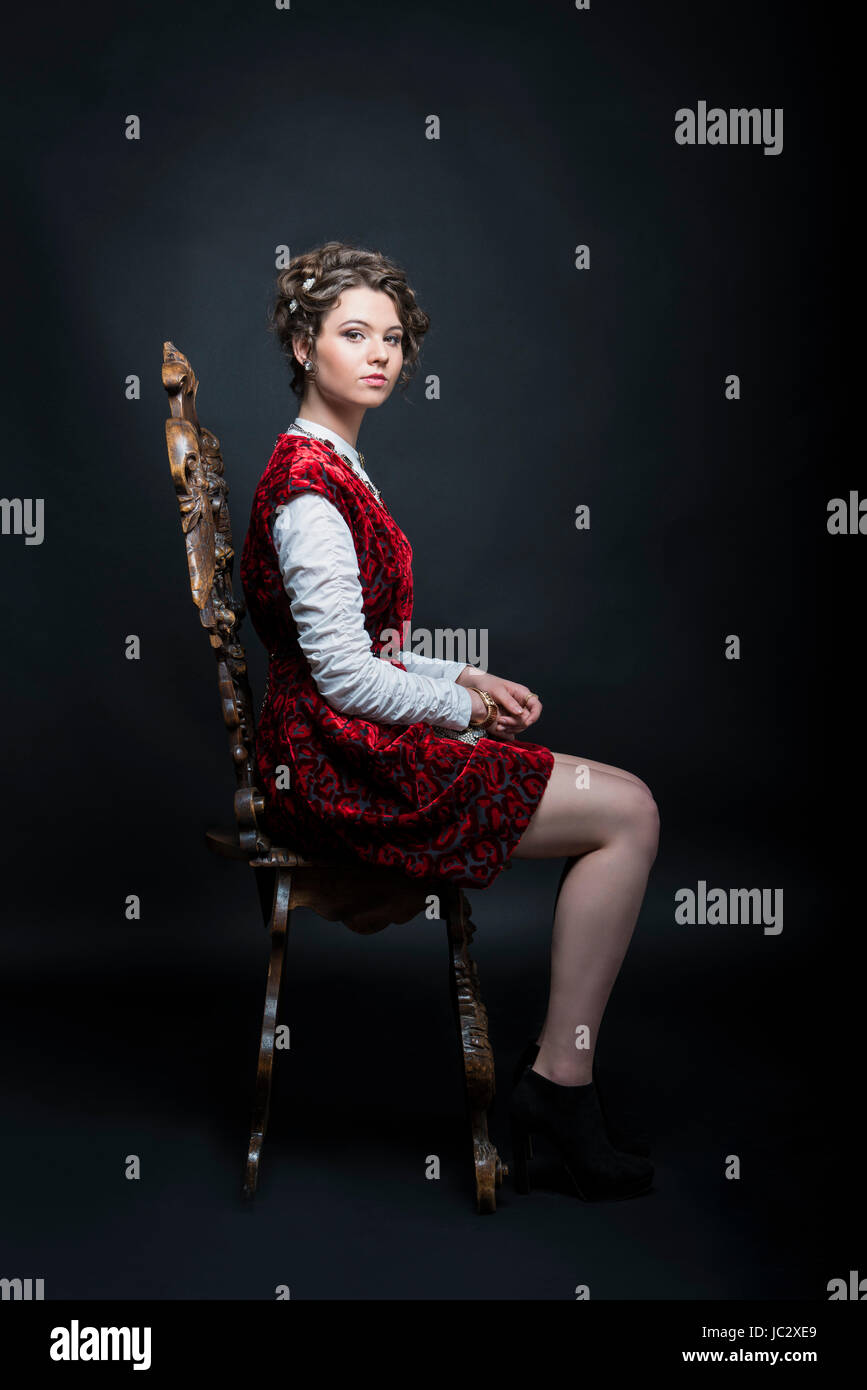 Portrait of beautiful Caucasian model in red Victorian-style velvet ...