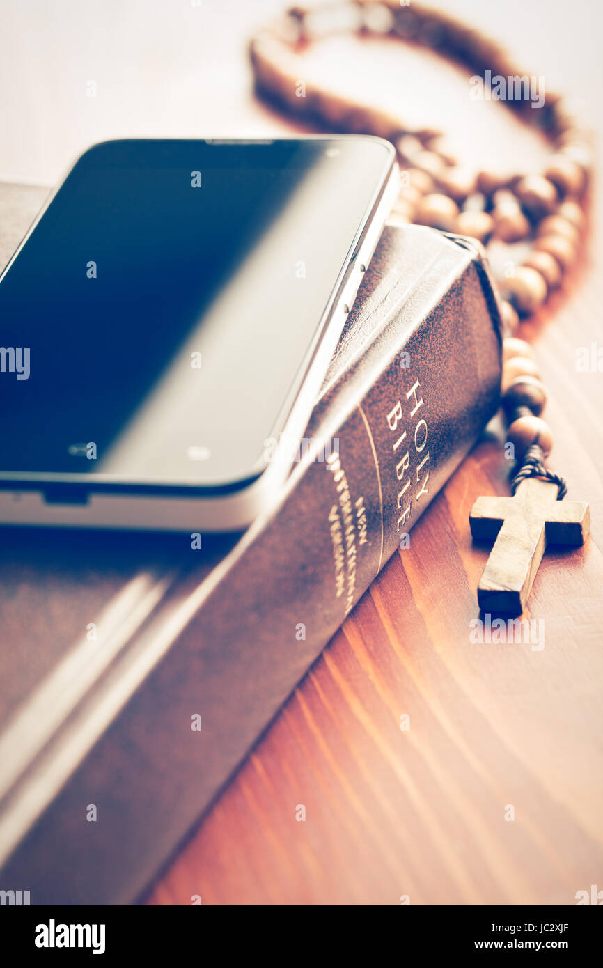 the smartphone with holy bible and rosary Stock Photo - Alamy