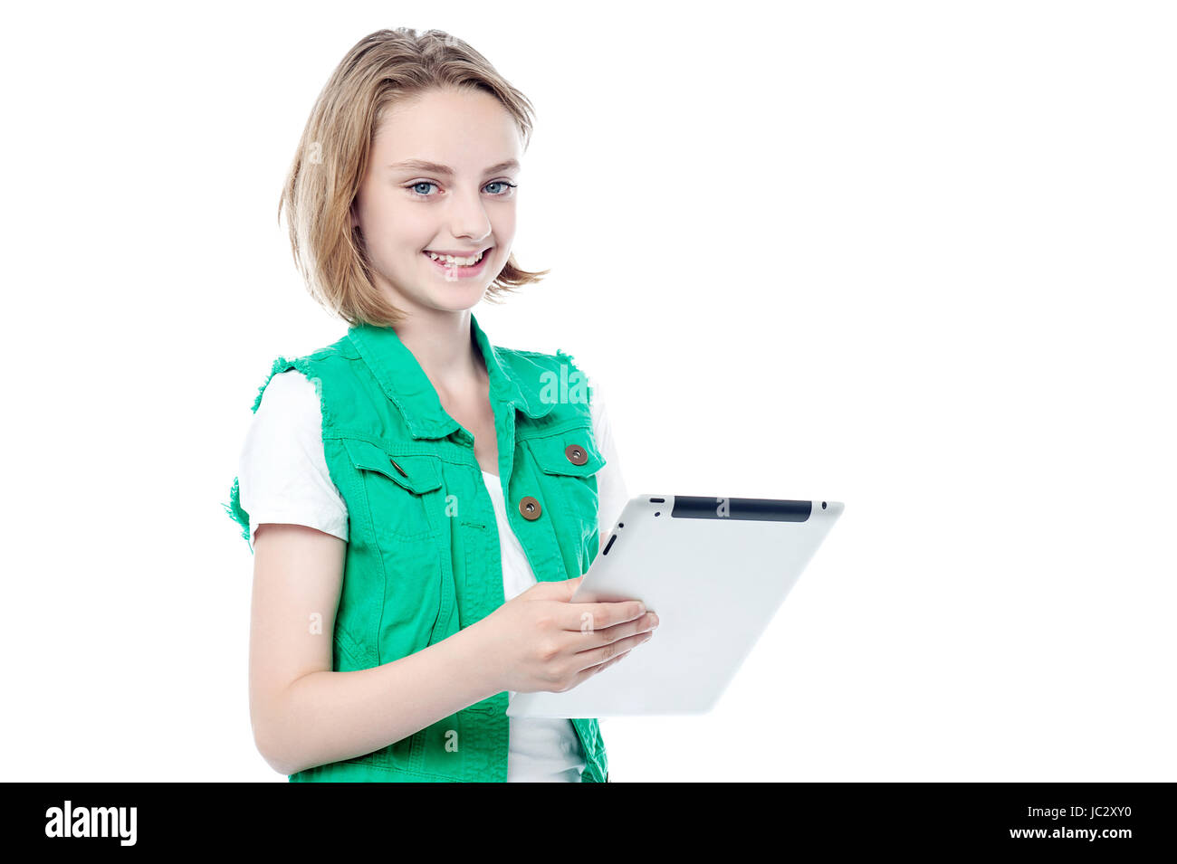 Trendy smiling young girl posing with her tablet computer Stock Photo ...