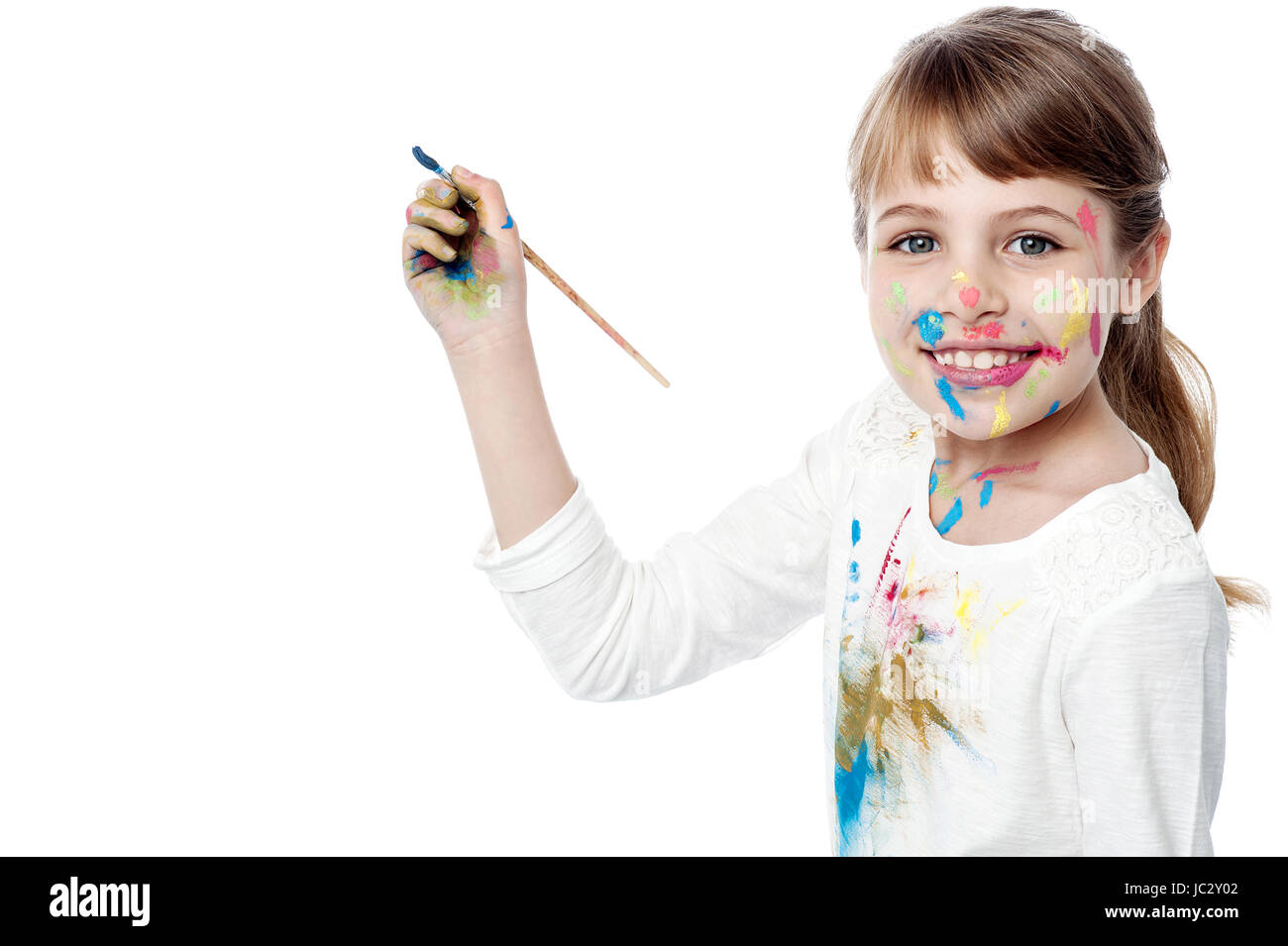 Smiling little girl painting with colorful paints Stock Photo - Alamy