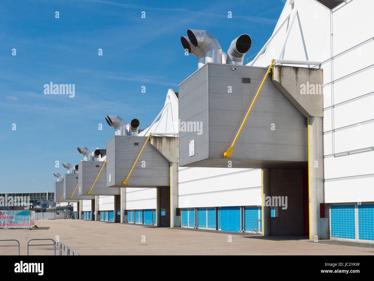 exhaust pipes above the entrance of a large industrial building Stock ...