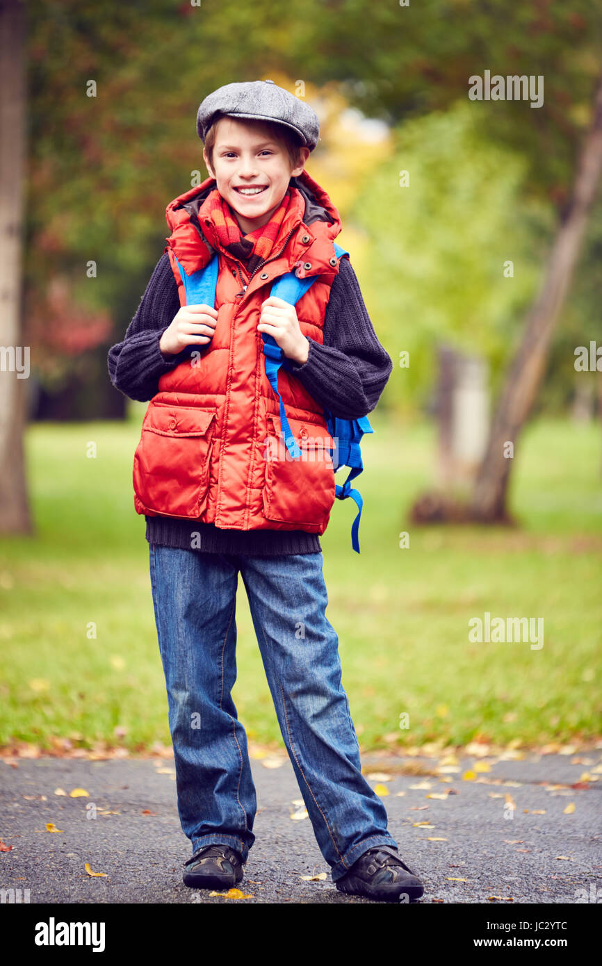 Portrait of stylish schoolboy with backpack looking at camera Stock ...