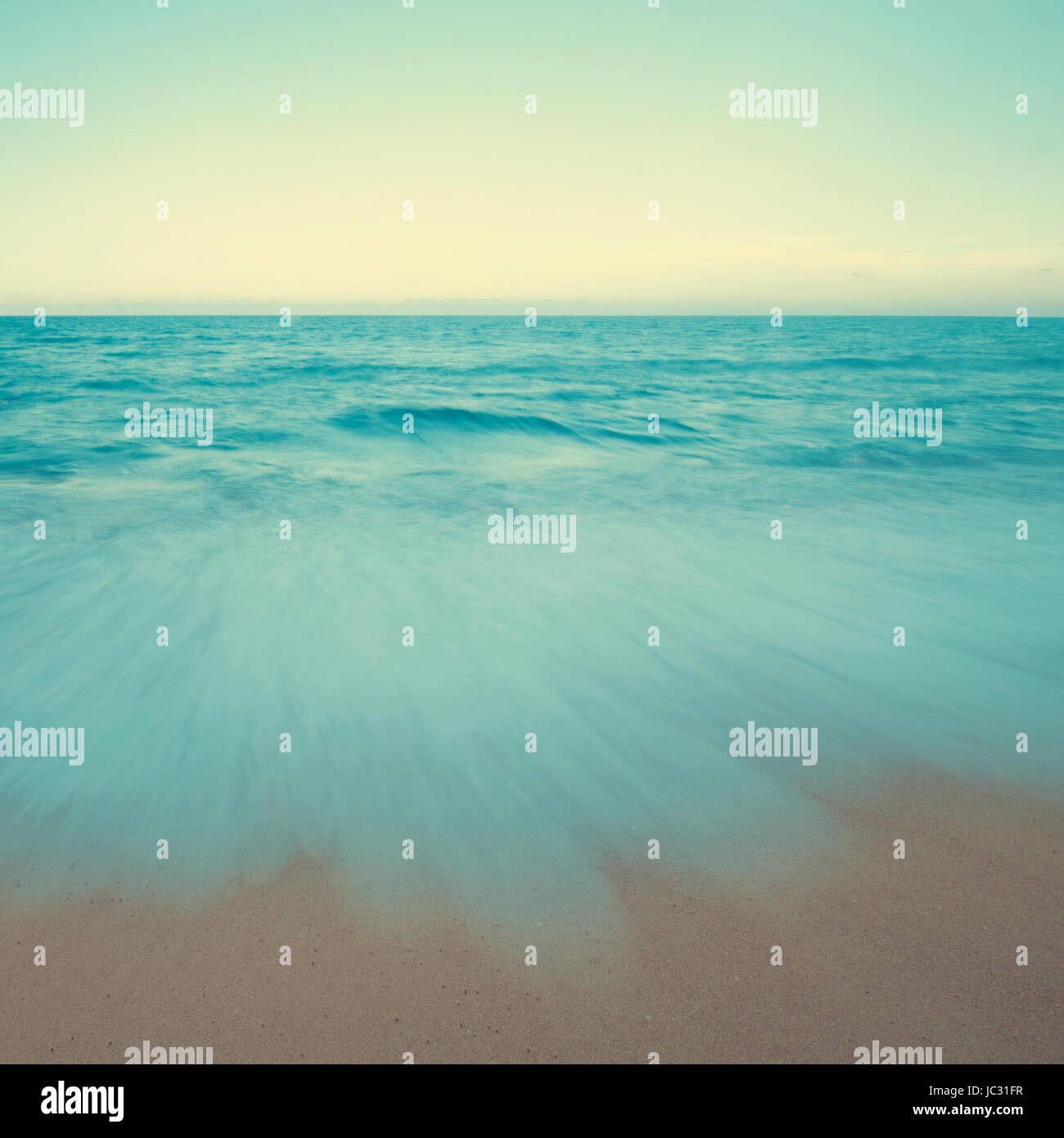 Vintage beach scene in sunset, slow shutter with moving waves Stock ...